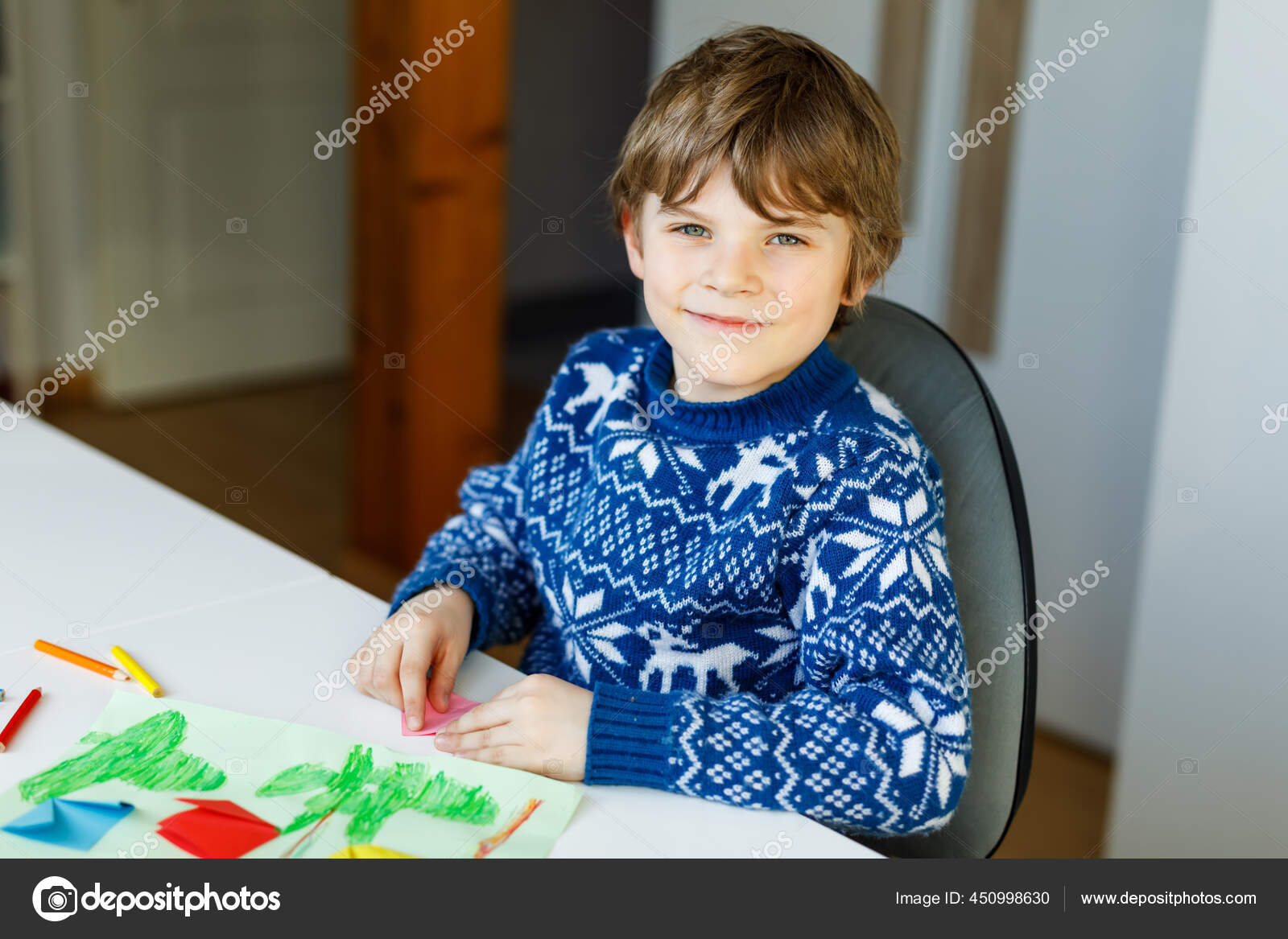 Little kid boy making paper origami tulip flowers for a postcard for ...