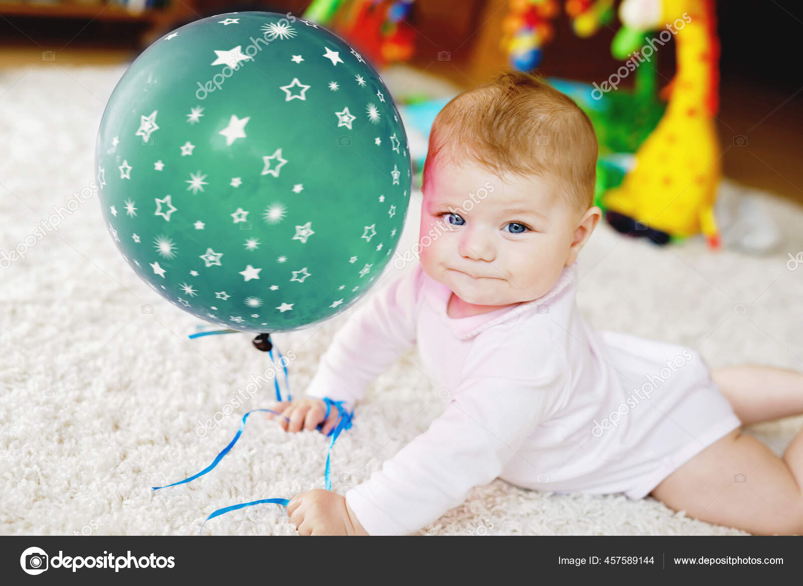 Cute baby playing with red air balloon. New born child, little girl ...