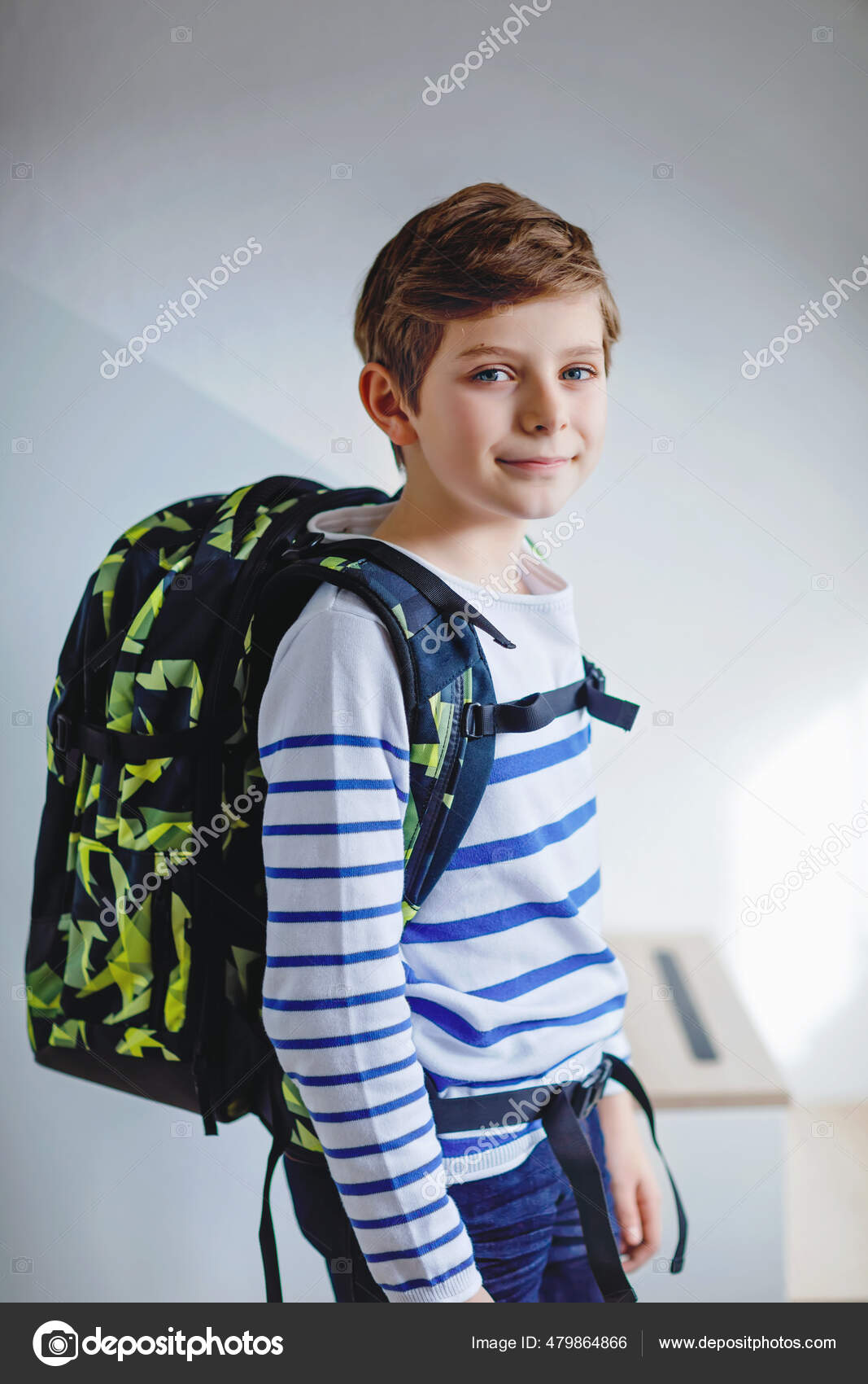Beautiful kid boy with schoolbag rucksack standing in room in early ...