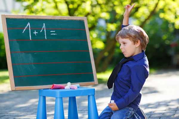 Little boy at blackboard practicing mathematics ⬇ Stock Photo, Image by ...