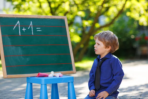Little boy at blackboard practicing mathematics ⬇ Stock Photo, Image by ...