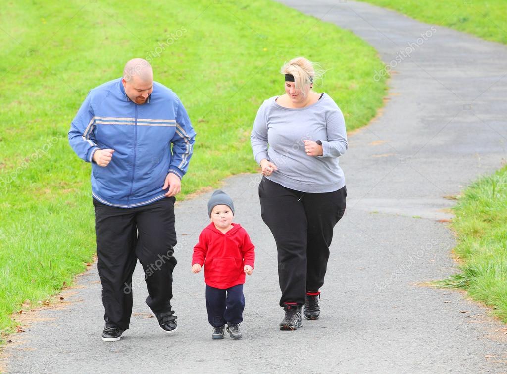 Overweight parents with her son walking together Stock Photo by ...