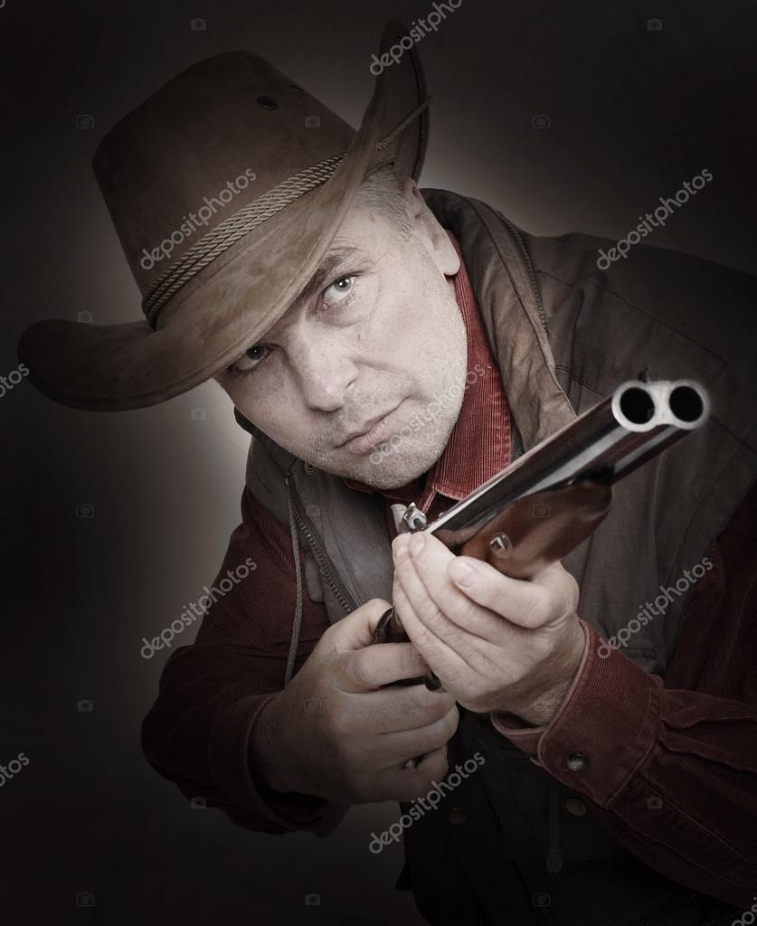 Cowboy with shotgun aiming — Stock Photo © vladvitek #65977645