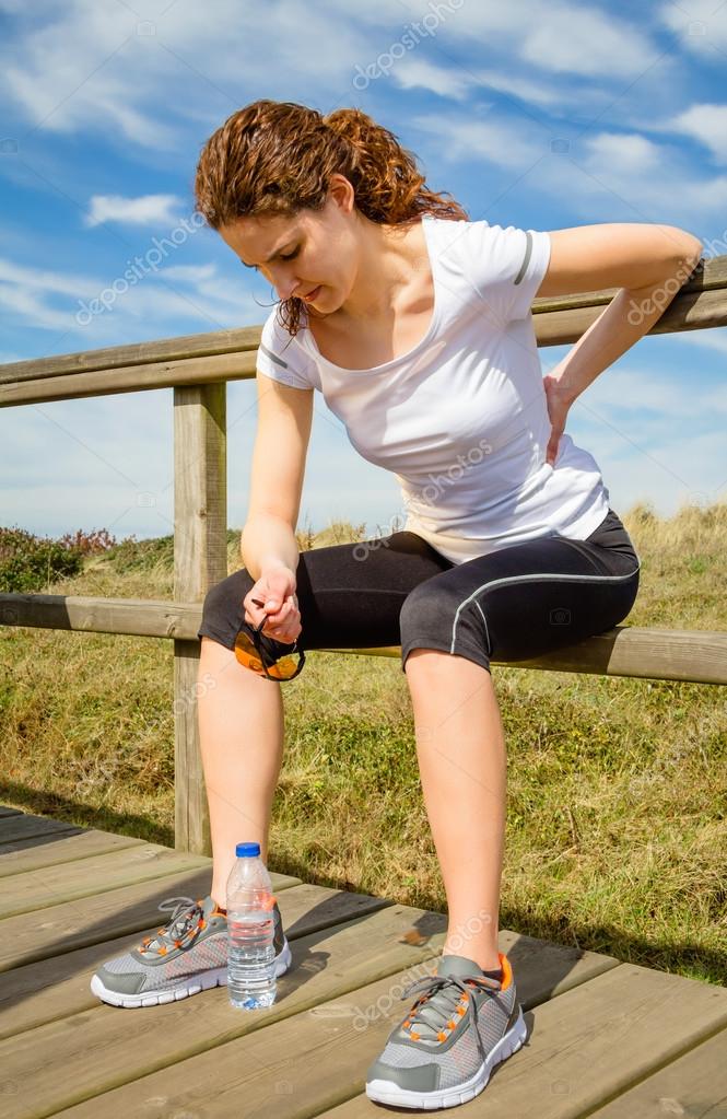 Athletic woman touching her back muscles by injury — Stock Photo ...