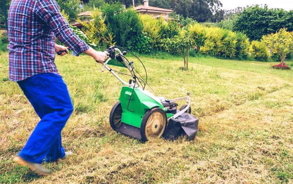 Young man mowing the lawn with lawnmower — Stock Photo © doble.dphoto ...
