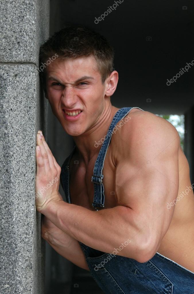 Muscular Worker Pushing Stone Blocks Stock Photo by ©wrangel 60335347