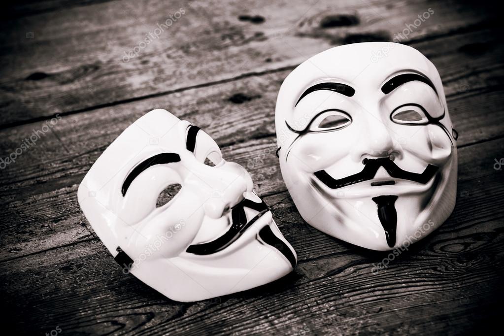 White and yellow anonymous masks on wood background – Stock Editorial ...