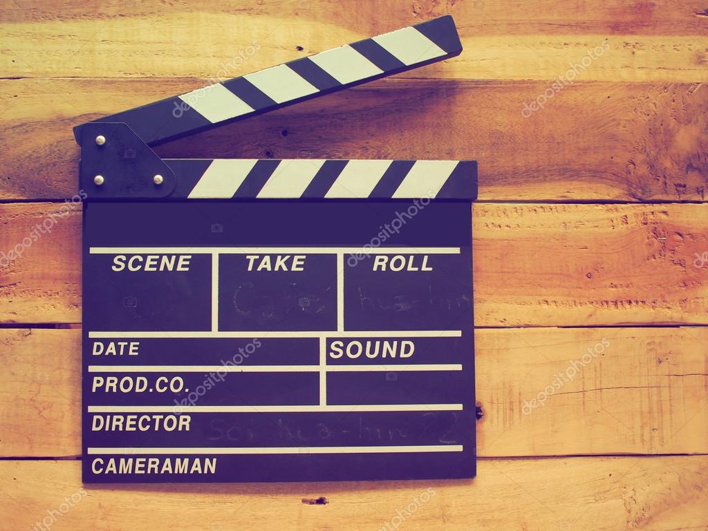 Clapper board on wood background vintage color tone Stock Photo by ...