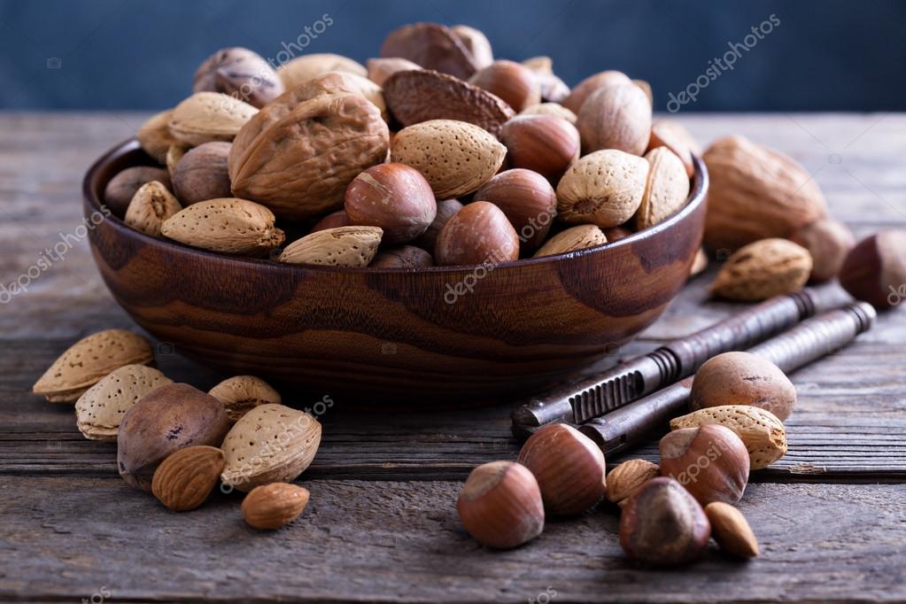 Variety of nuts with shells in a bowl Stock Photo by ©fahrwasser 93441556