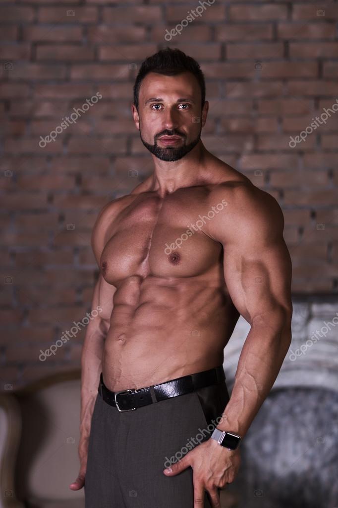 Muscle man poses shows press Stock Photo by ©annamoskvina 111099286