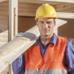 Construction worker working on building window Stock Photo by ...