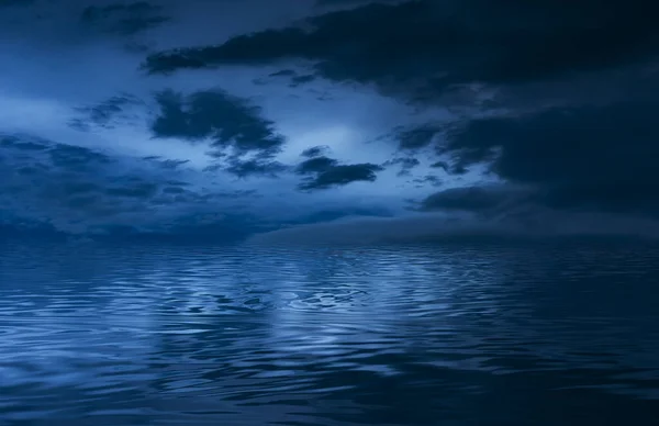 Night sky, horizon at sunset, moonlight, clouds, waves reflected in ...