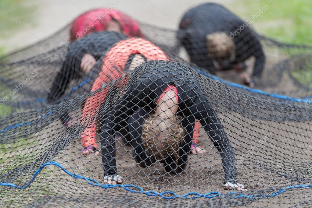 Crawling under the super net trap at Tough Viking obstacle cours ...