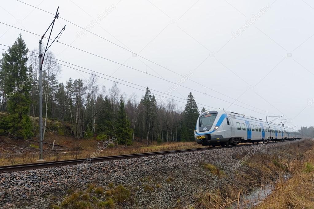 Commuter train coming through the the landscape in a curve – Stock ...