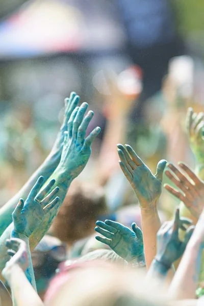 Happy people rising their hands in green at Stockholm Color Run - Stock ...