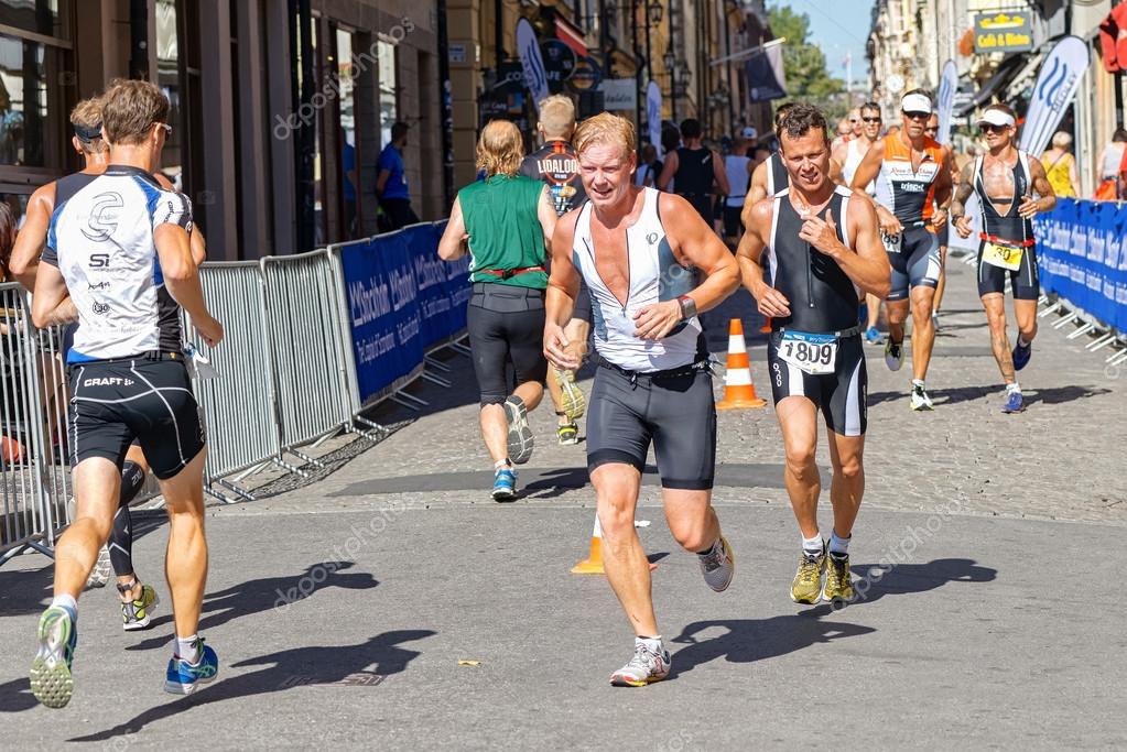Triathletes running at the cobblestones in the old town at the I ...