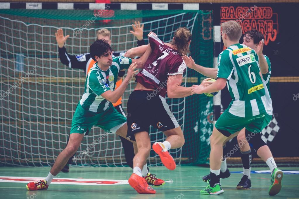 Intense physical play at the line in the Handball game between H ...