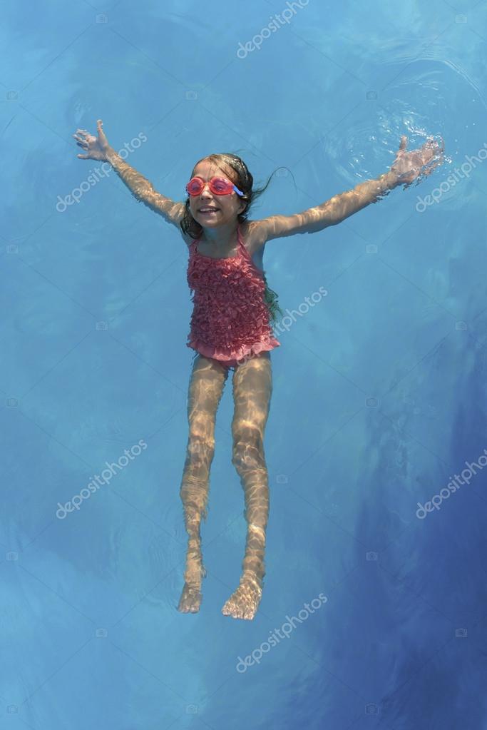 Young Girl Floating on Water Surface — Stock Photo © MidoSemsem #92040746