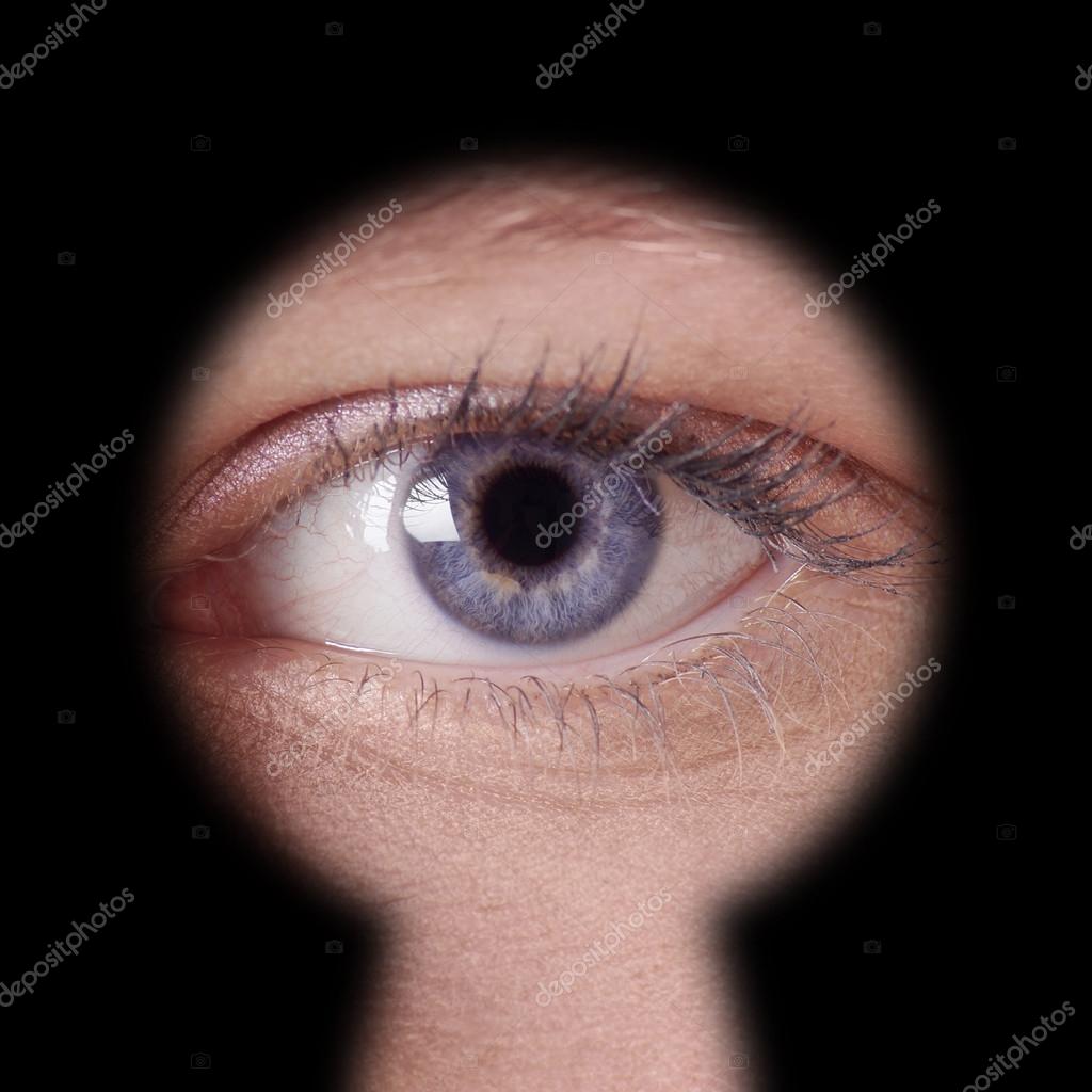 Eye looking through keyhole — Stock Photo © buecax #67636671
