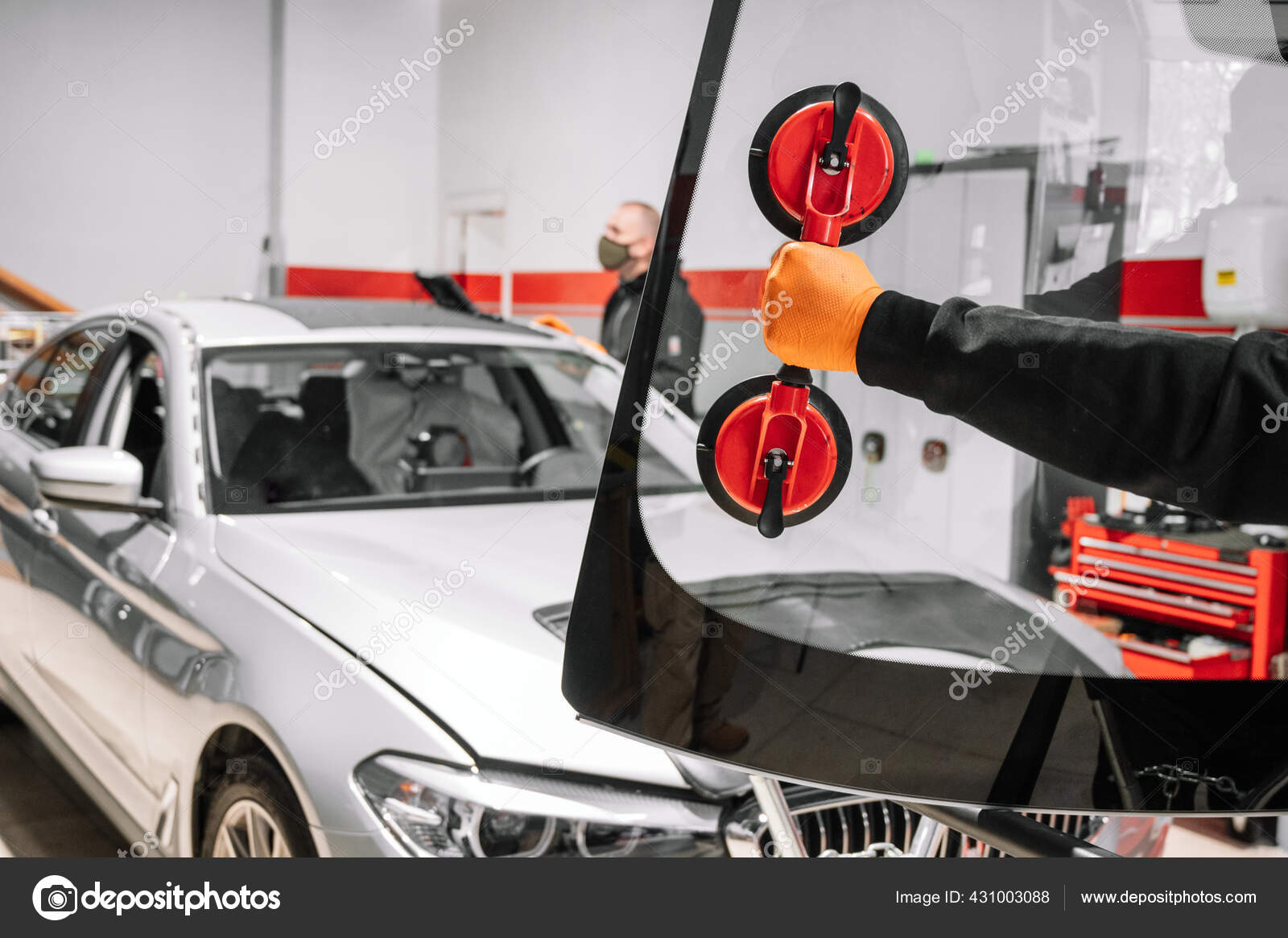 Automobile technician worker replacing windscreen or windshield of a ...