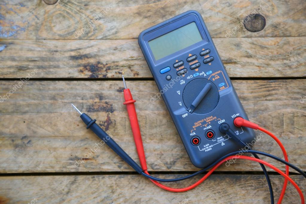 Close-up of digital multimeter on wooden background, Worker used ...