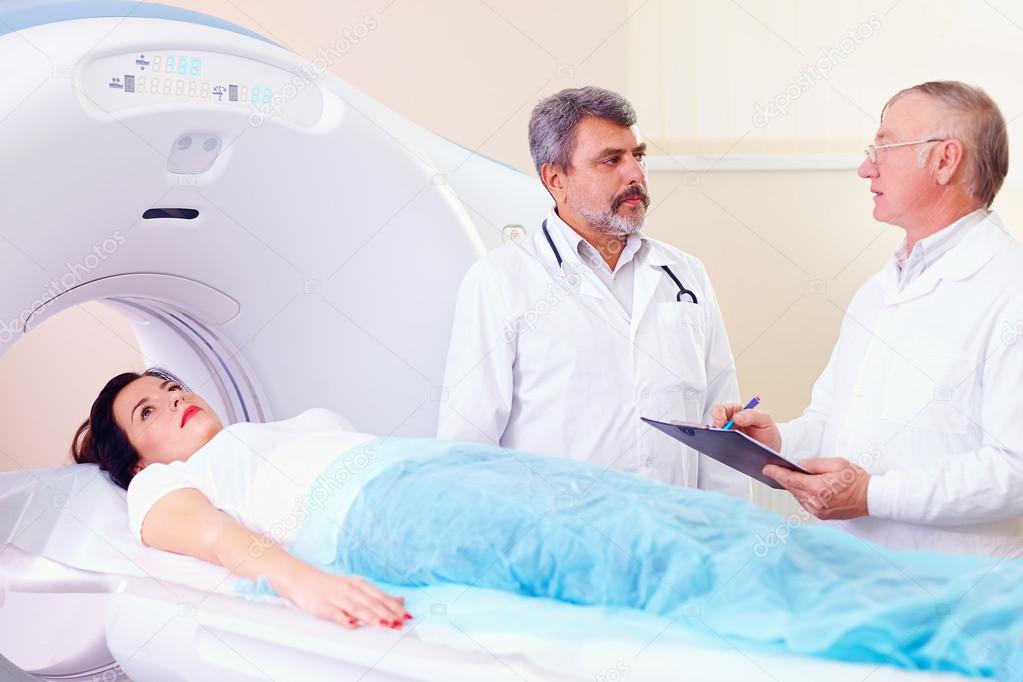 Two doctors preparing patient to CT scanner procedure — Stock Photo ...