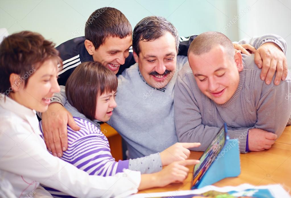 Group of happy people with disability having fun with tablet — Stock ...
