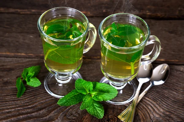 Hot mint tea in glass cup — Stock Photo © Anna_Shepulova #84495554
