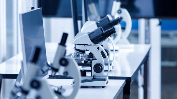Close up shot of two eyes viewfinder scientific microscope in row of ...