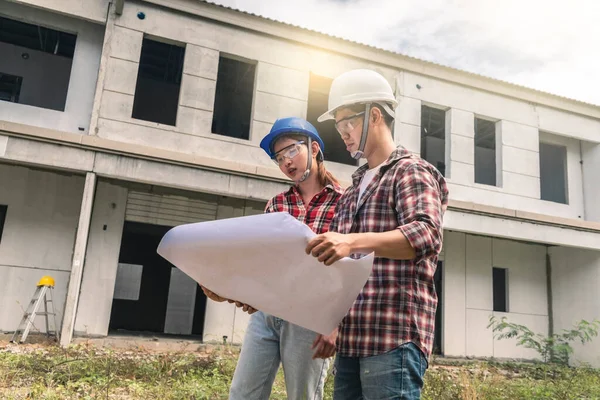 Young asian couple checking house with foreman engineering home ...