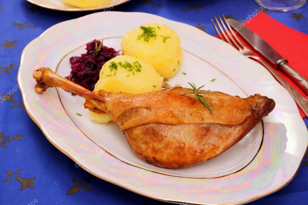 Roasted goose leg with red cabbage and dumplings Stock Photo by ...