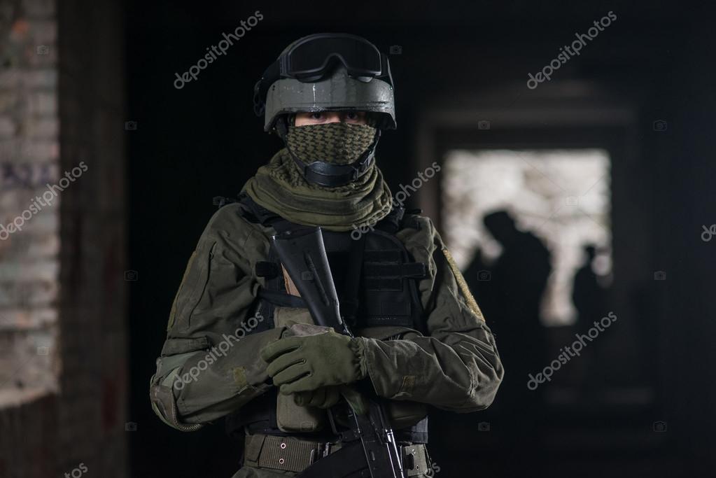 Fully equipped military men with automatic weapons playing airsoft ...