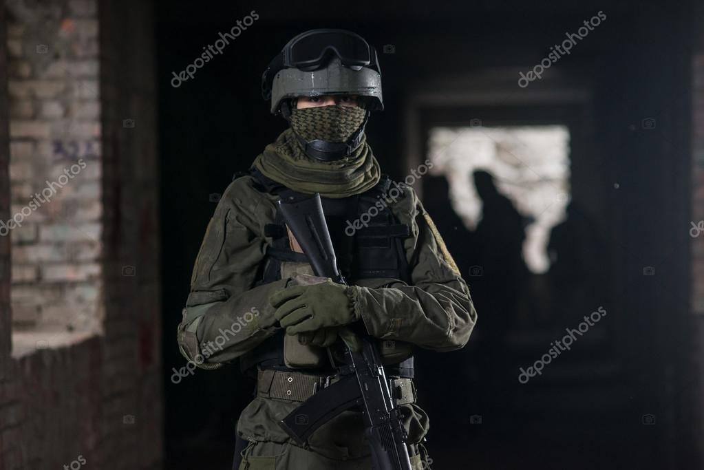 Fully equipped military men with automatic weapons playing airsoft ...