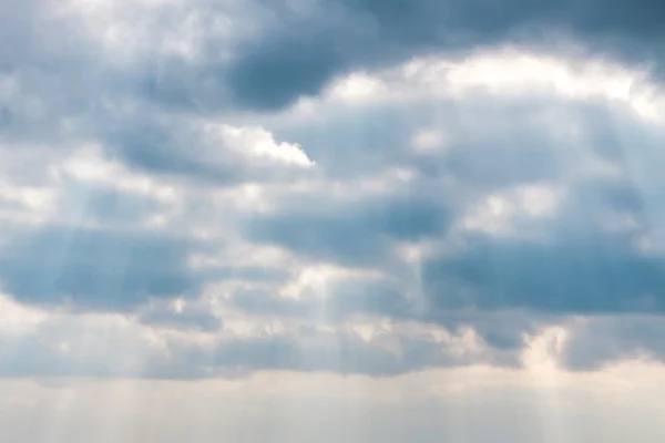 Direct rays shine through the clouds in the afternoon - Stock Image ...