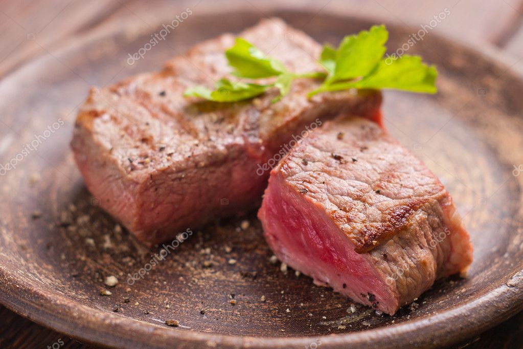 Rare beef steak on rustik plate Stock Photo by ©Kasza 69654607