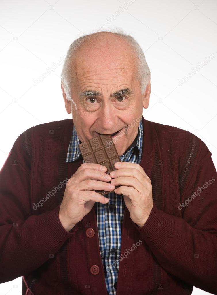 Old man eating chocolate — Stock Photo © s2uphoto #102510344