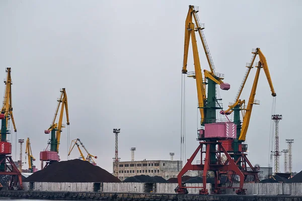 Massive harbor cranes in seaport. Heavy load dockside cranes in port ...