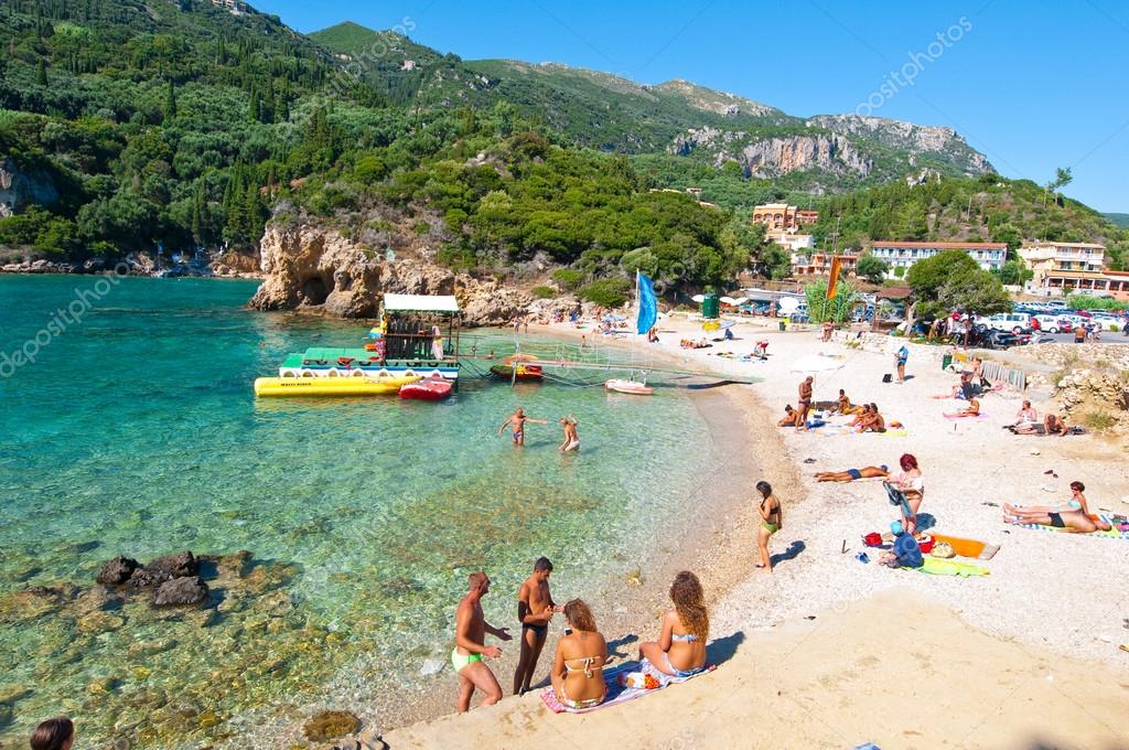 CORFU-AUGUST 26: Palaiokastritsa beach, people sunbathe on the beach on ...