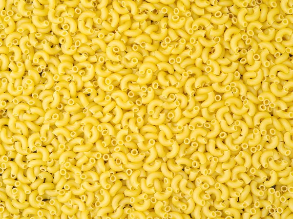 Golden pasta in pile Stock Photo by ©jianghongyan 121142364