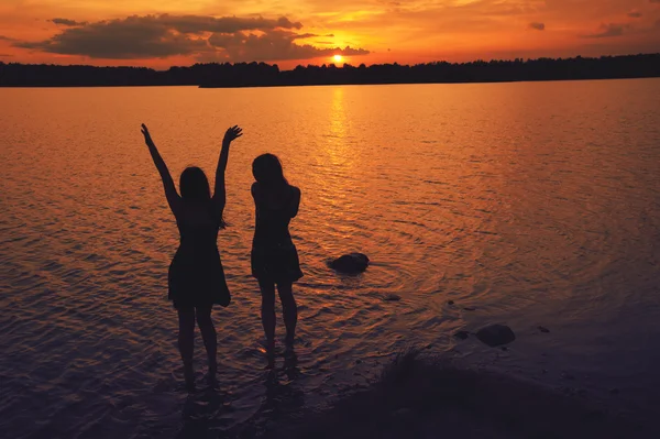 Two young girls watching a beautiful sunset Stock Photos, Royalty Free ...