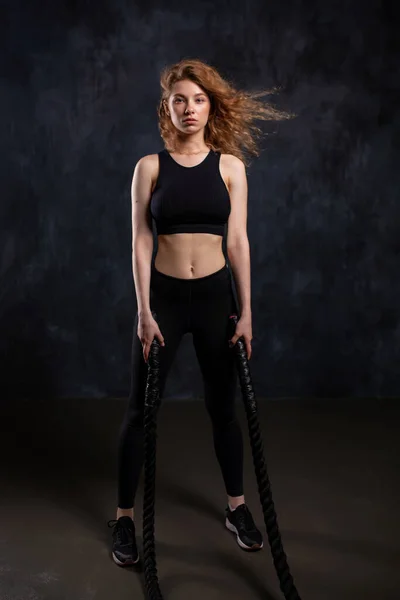 Athletic Female in a Gym Exercises with Battle Ropes During Her Cross ...