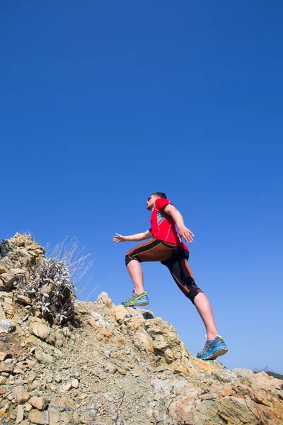 Mountain running.Man running on a rural road during sunset in the ...