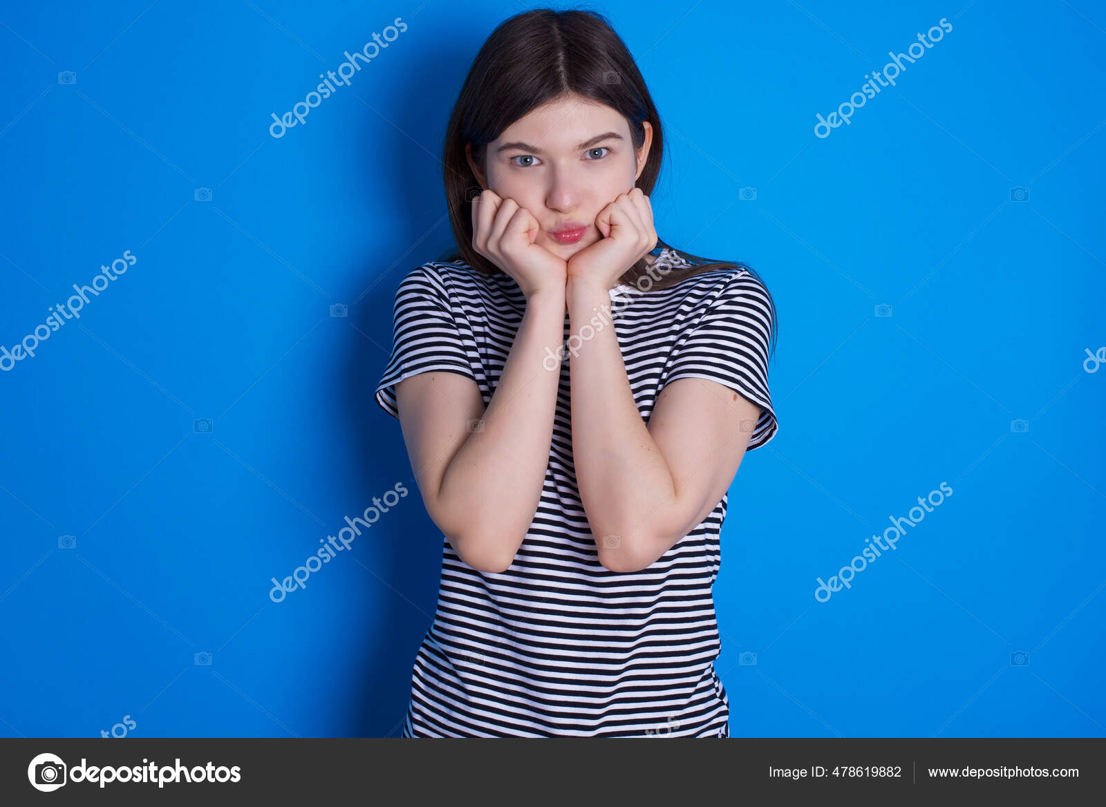 Young Woman Surprised Expression Keeps Hands Chin Keeps Lips Folded ...