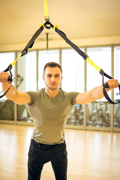 Suspension straps training in modern fitness facility - Stock Image ...