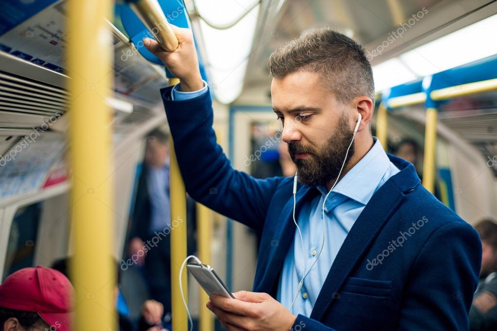 Serious businessman travelling to work. — Stock Photo © halfpoint ...