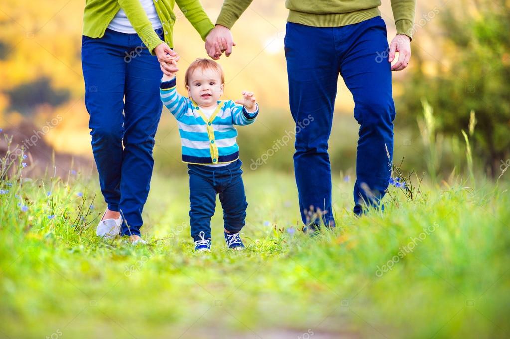Parents with son making first steps Stock Photo by ©halfpoint 103592750