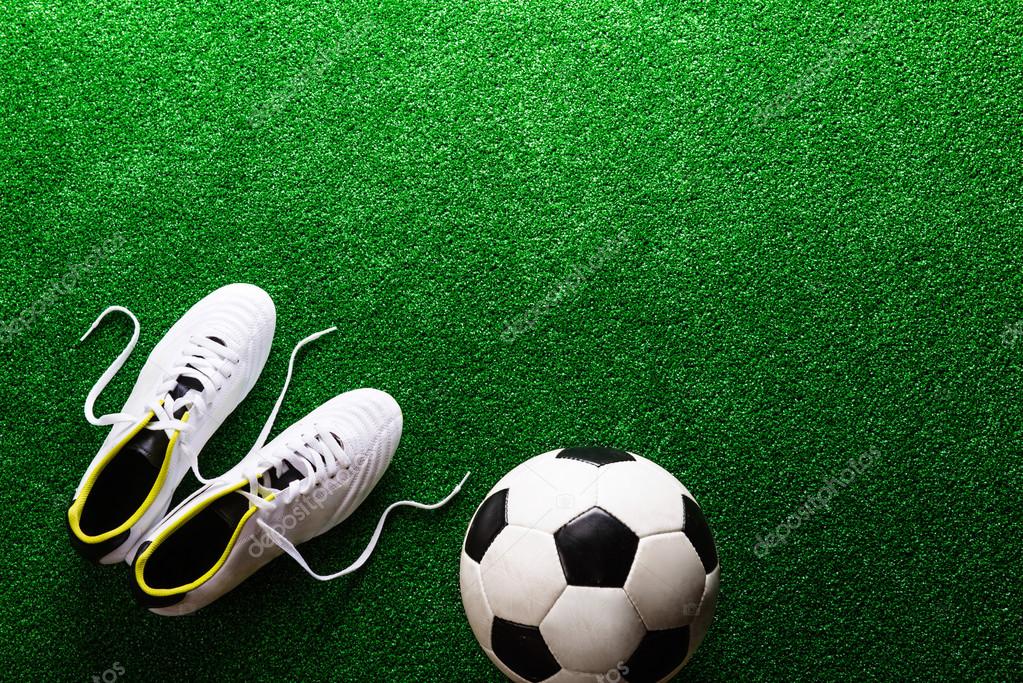 Soccer ball and boots on grass Stock Photo by ©halfpoint 112331030