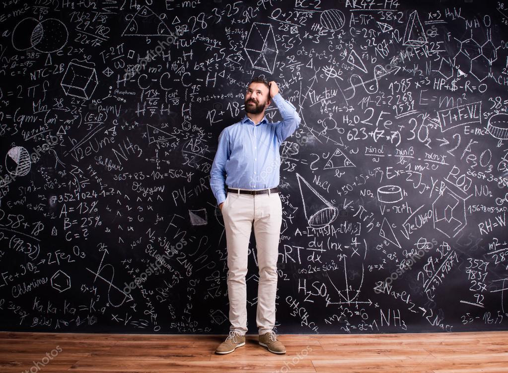 Teacher at blackboard with mathematical symbols — Stock Photo ...