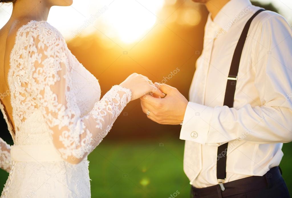 Wedding couple holding hands — Stock Photo © halfpoint #62786759