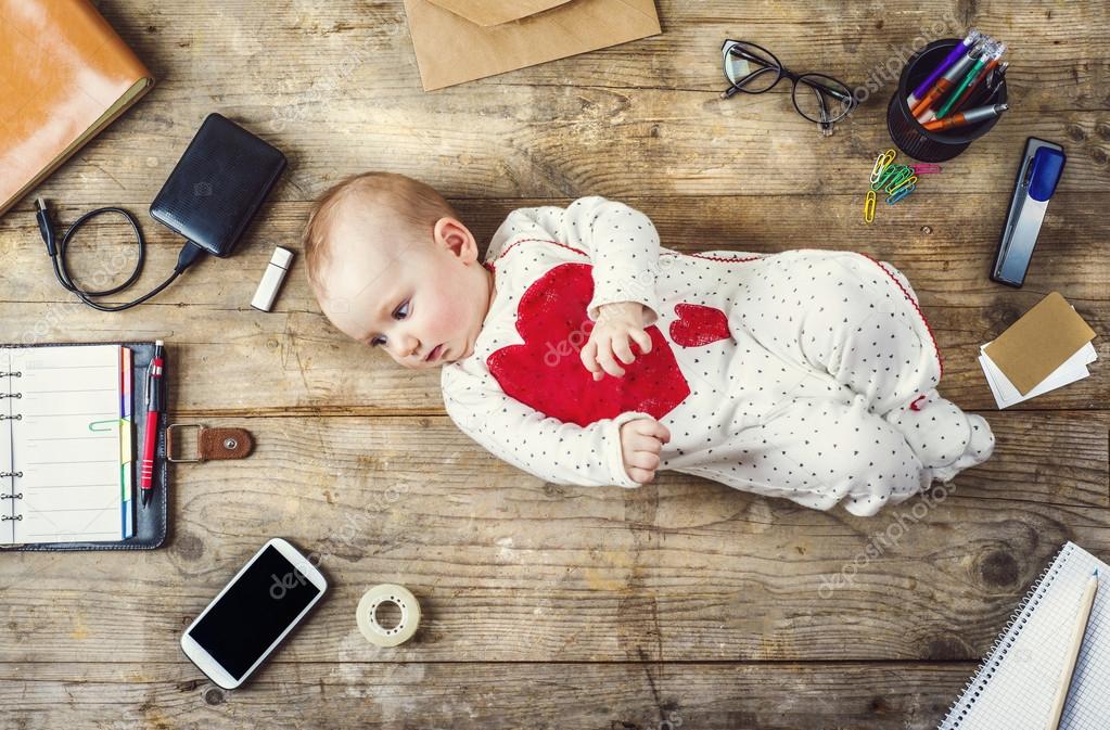 Desk with office supplies and little baby Stock Photo by ©halfpoint ...